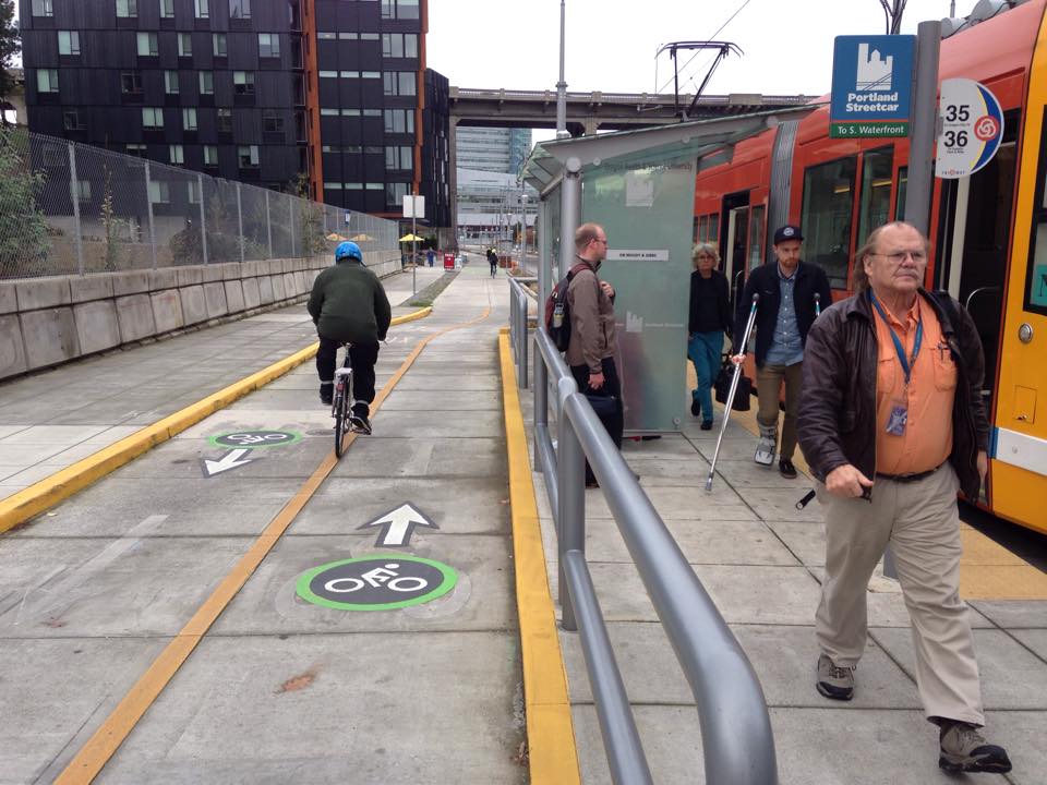 Shared use path passes a street-car stop. – University Bike Programs